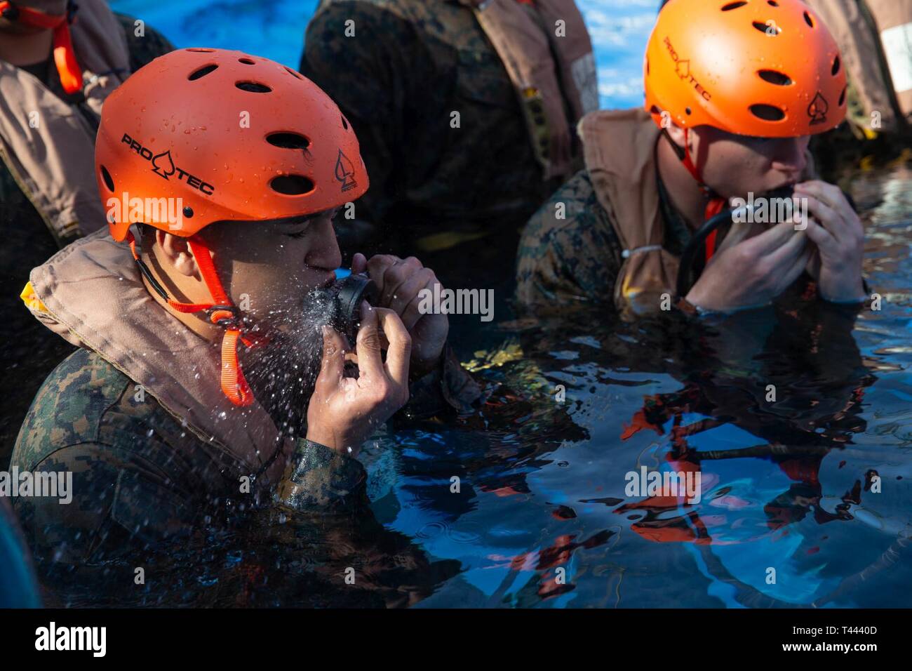 U.S. Marines with Headquarters Battalion, 3rd Marine Division, receive ...
