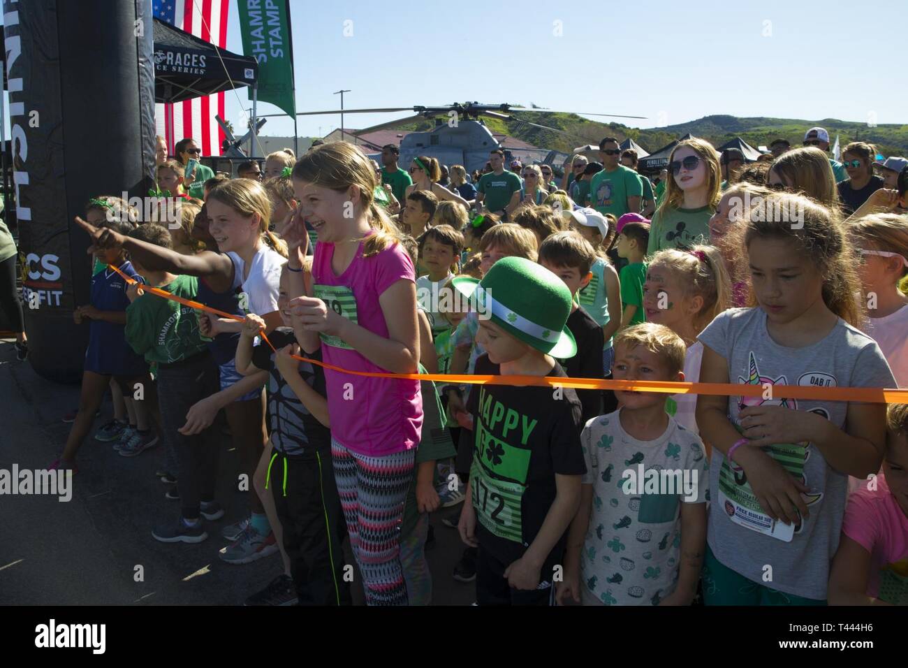 Run participants wait for the start of the kids one mile run during the ...
