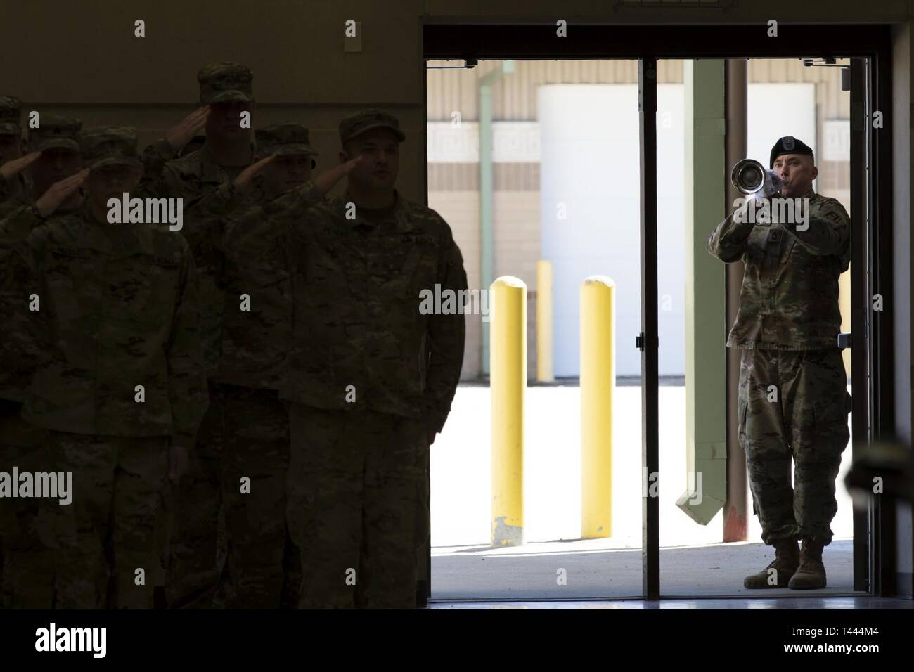 The bugler stands just outside the formation to play Taps during the ...