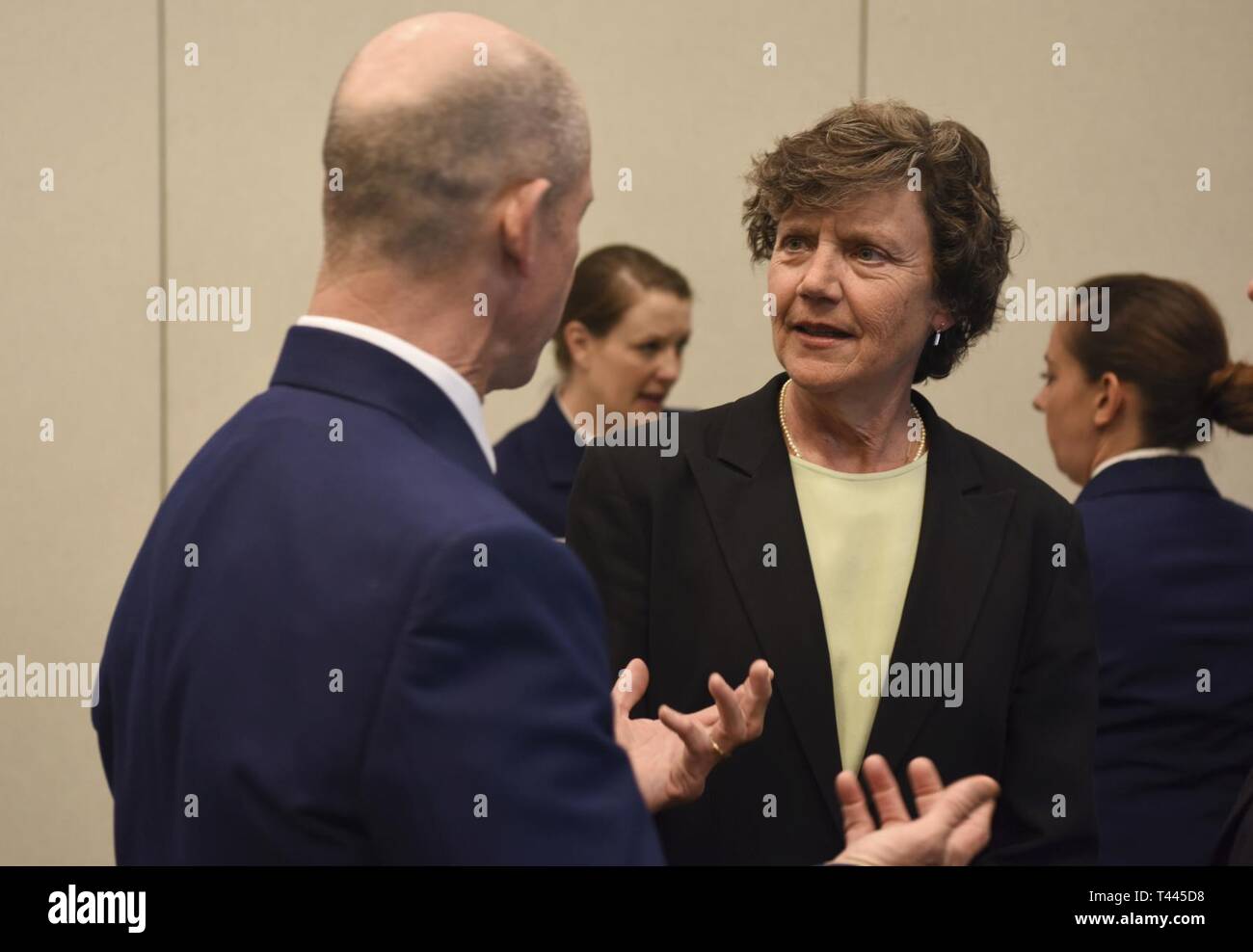 Elizabeth "Betty" Uhrig speaks with Adm. Charles Ray, U.S. Coast Guard ...