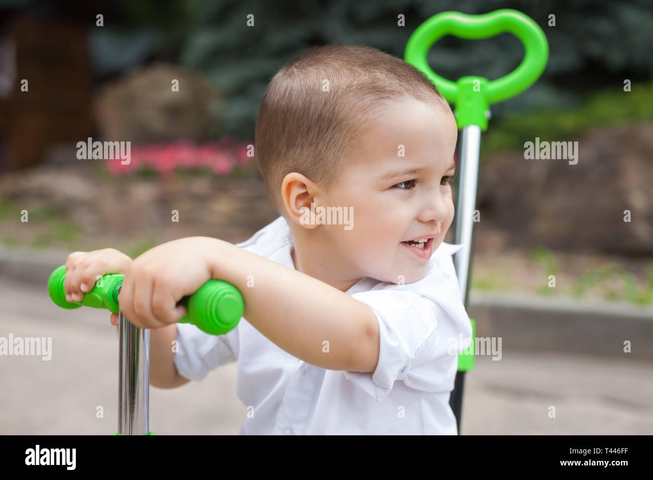 Happy child riding tricycle hi-res stock photography and images - Alamy