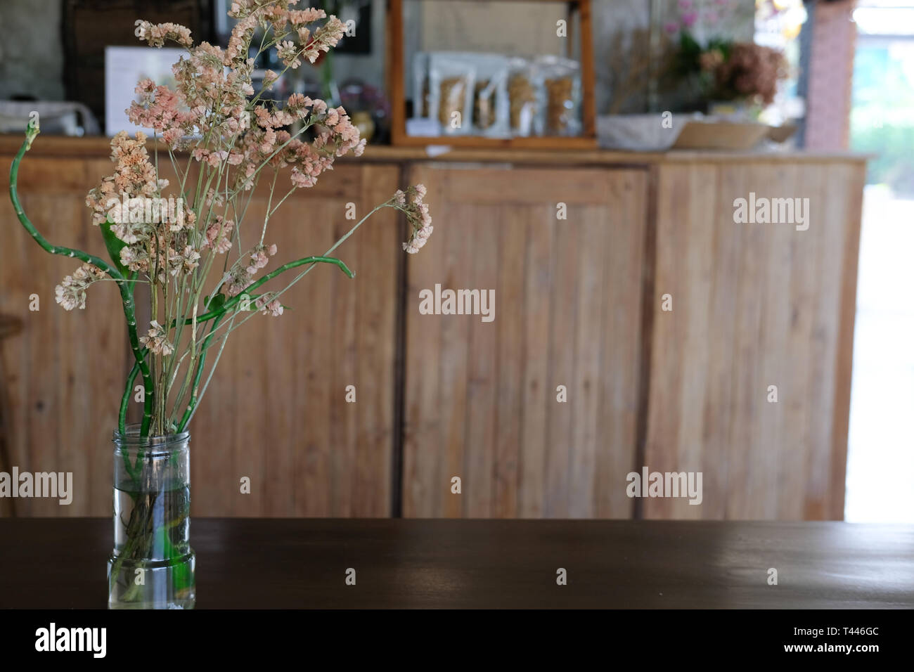 flower in vase on wooden coffee table in cafe. interior decoration ...
