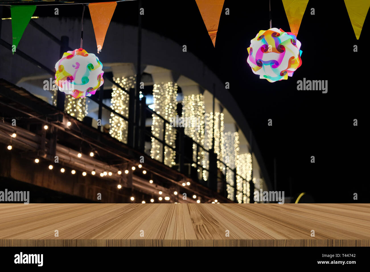 colorful lantern lamp with light on bridge at night with wood table for ...