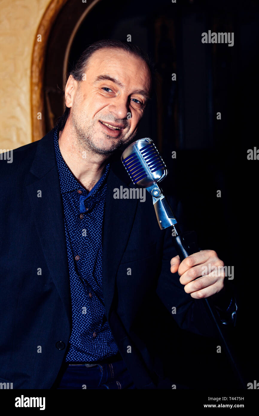 50 plus singer men with old school microphone. Jazz singer with stylish ...