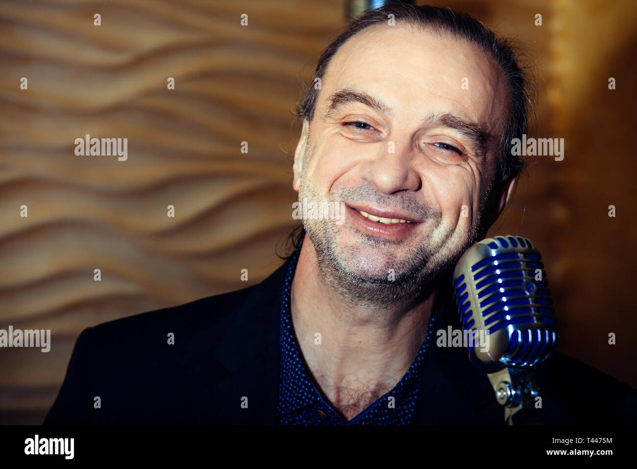 50 plus singer men with old school microphone. Jazz singer with stylish ...