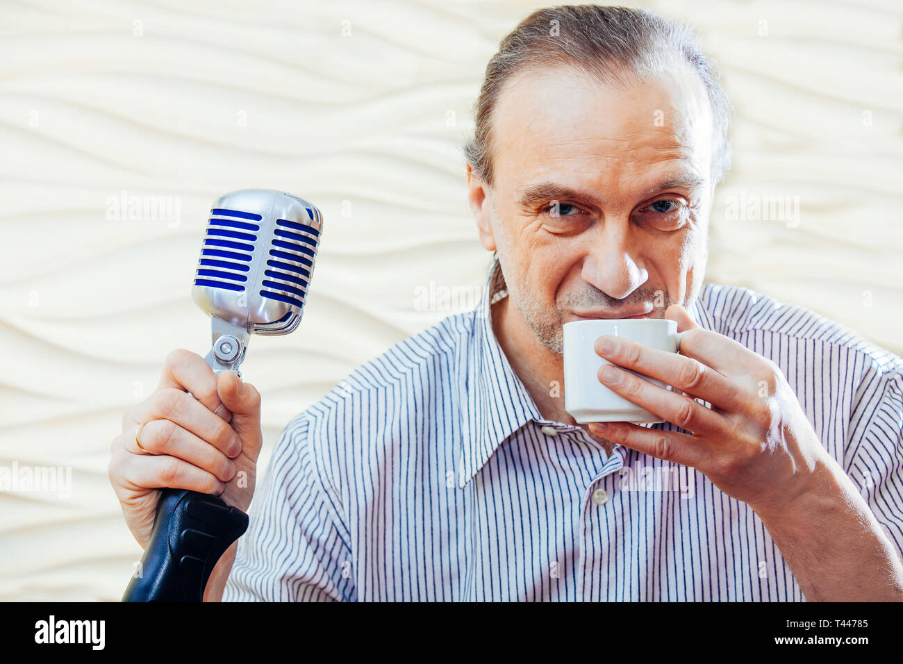 50 plus singer men with old school microphone. Jazz singer with stylish ...