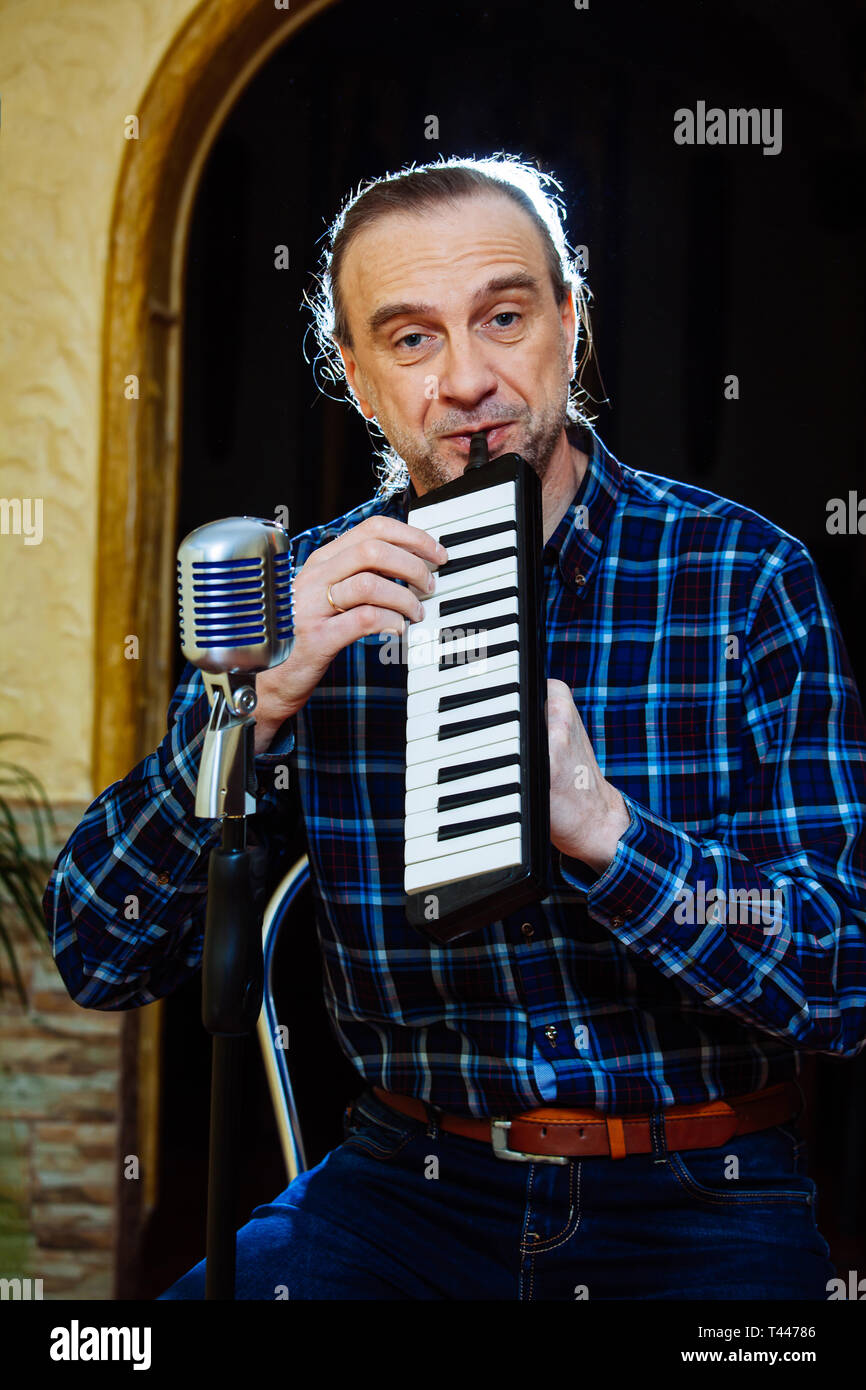 50 plus singer men with old school microphone. Jazz singer with stylish ...