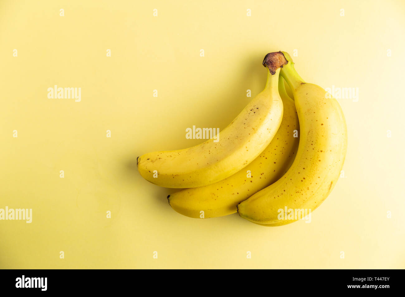 Ripe yellow bananas fruits, bunch of ripe bananas on yellow background ...