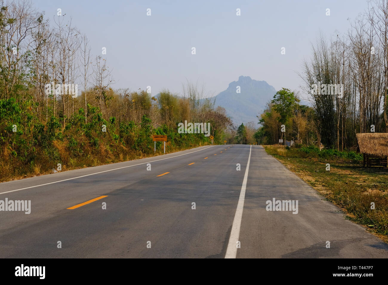 asphalt country road leading towards mountain in Thailand Stock Photo ...