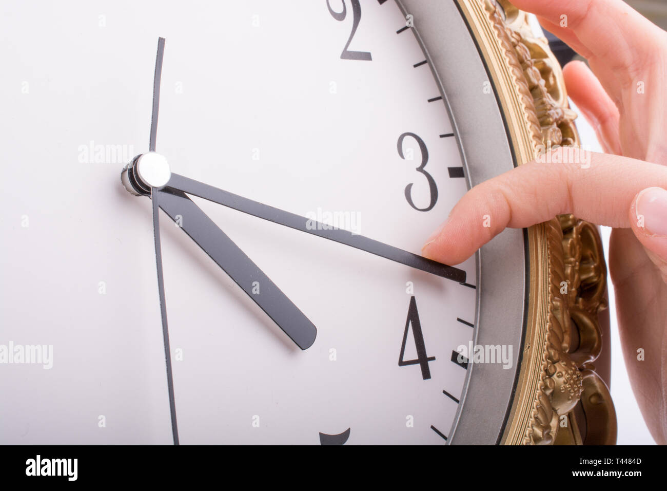 hand in touch with a clock on a white background Stock Photo - Alamy