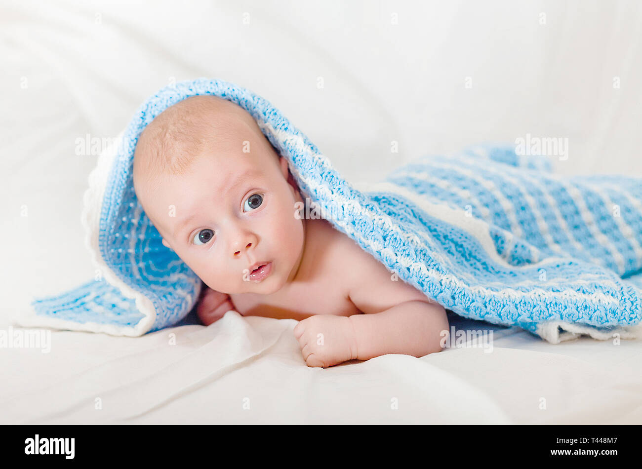 Portrait of a cute smiling infant baby crawling in a diaper, two-month ...