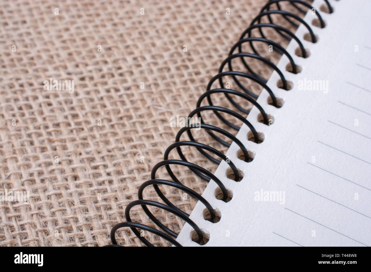 brown color spiral notebook placed on a canvas background Stock Photo ...