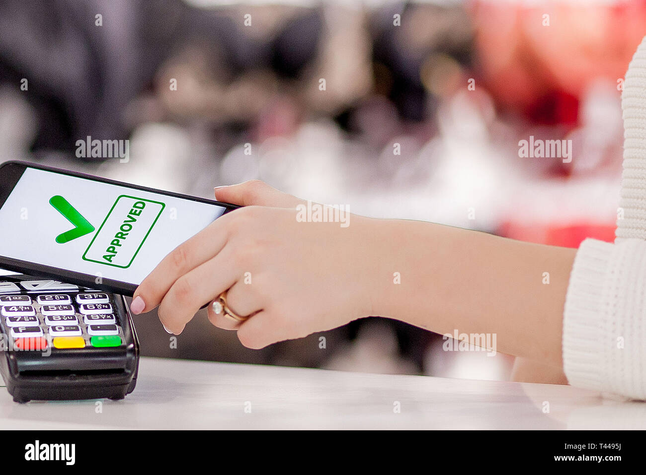 POS terminal, Payment Machine with mobile phone on store background ...