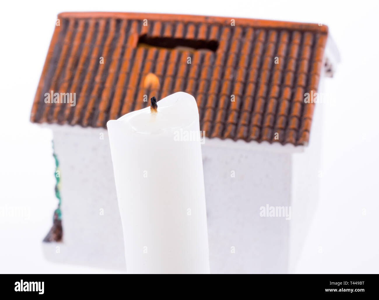 house and candle side by side on a white background Stock Photo - Alamy