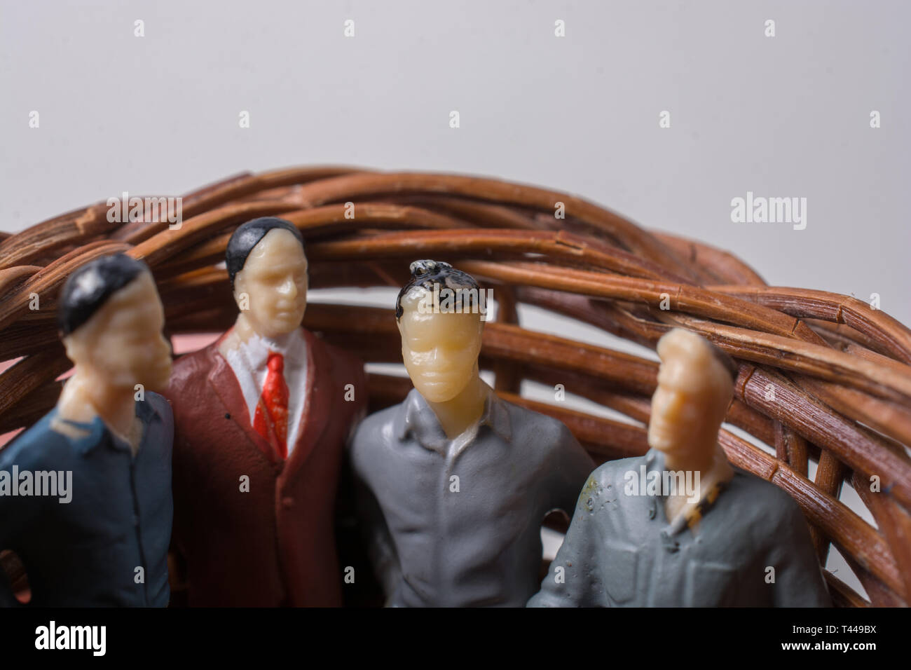 Tiny figurine of group of men miniature model in basket Stock Photo - Alamy