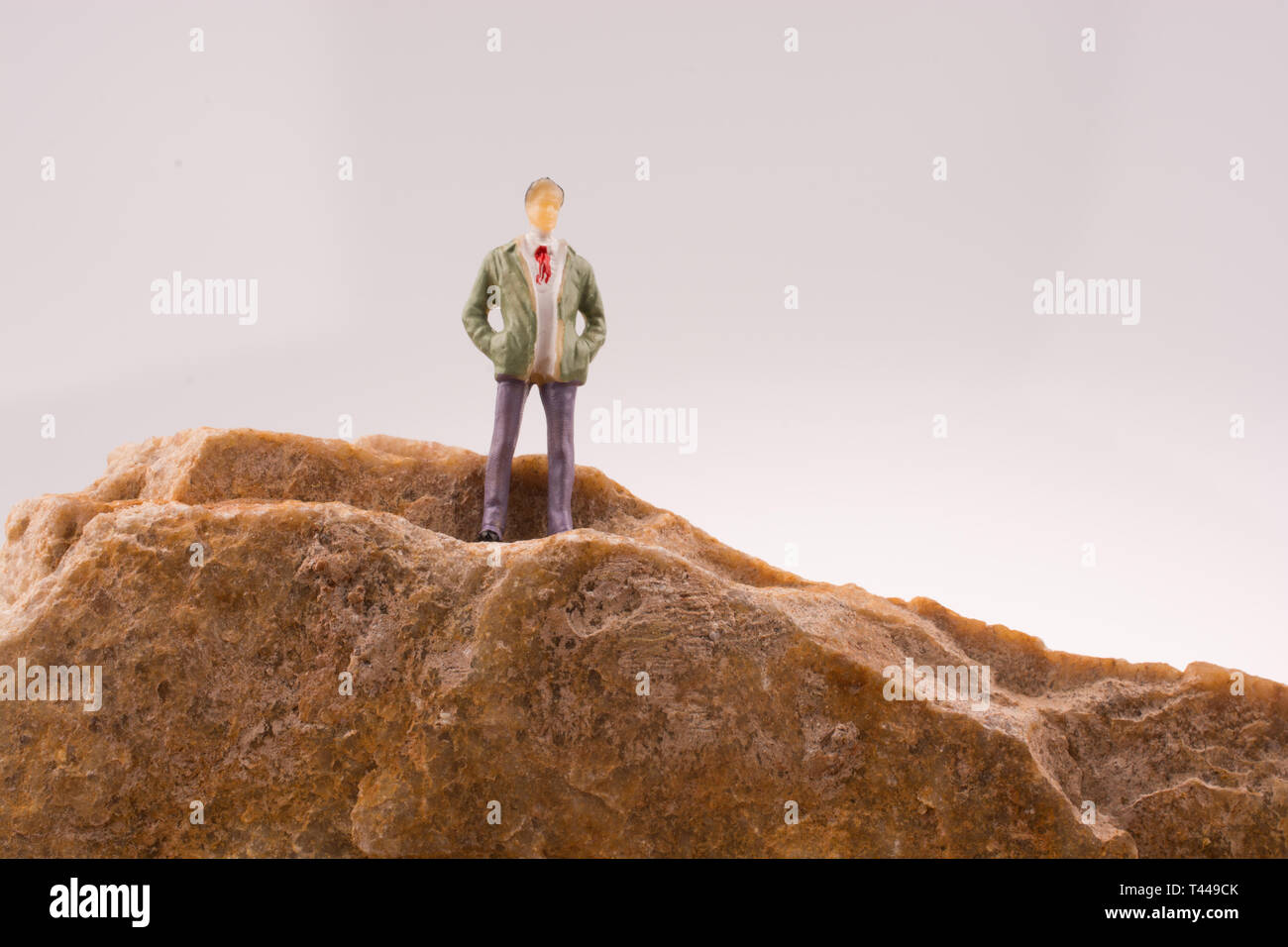 Human figure on rock on a white background Stock Photo - Alamy