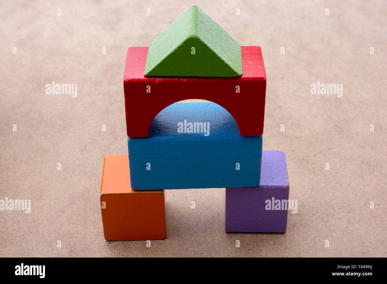 House shape formed out of building blocks on a brown background Stock ...
