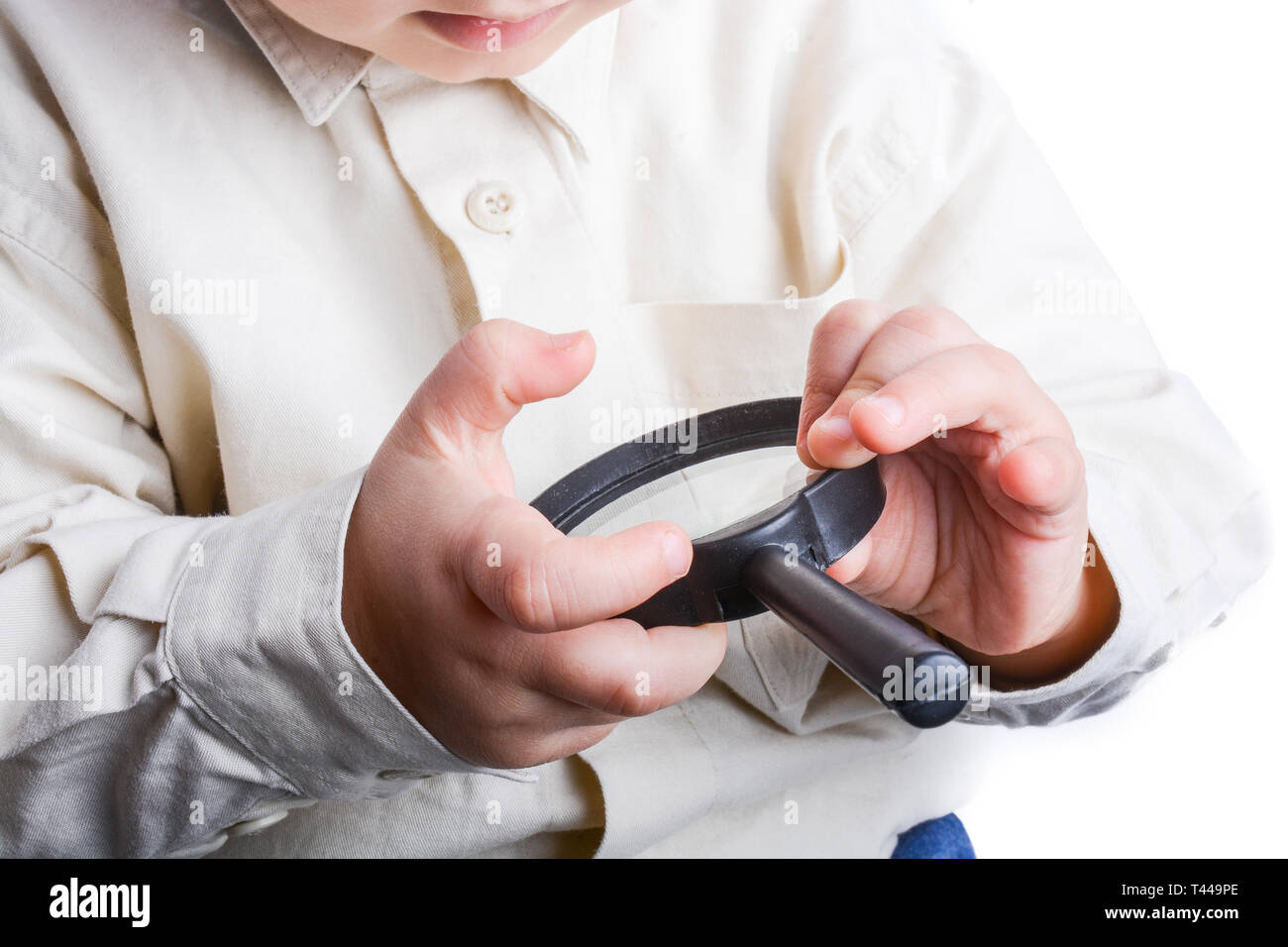 Baby holding a magnifying glass in hand on a white background Stock ...