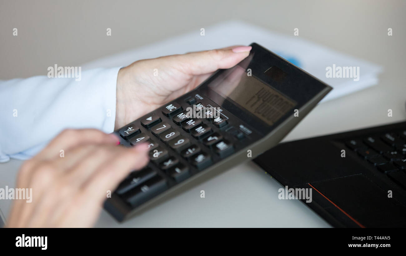 Businesswoman professional holding using office calculator calculate ...