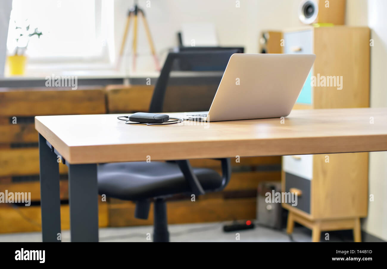 Empty office desk, laptop with connected generic usb device on it ...