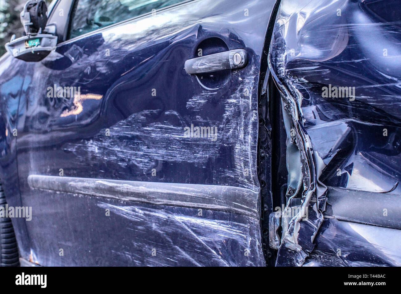 Detail of car after accident, side metal plates deformed after crash ...