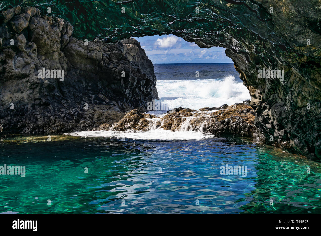 Charco azul volcanic cavern, natural volcanic ocean pool with turquoise ...