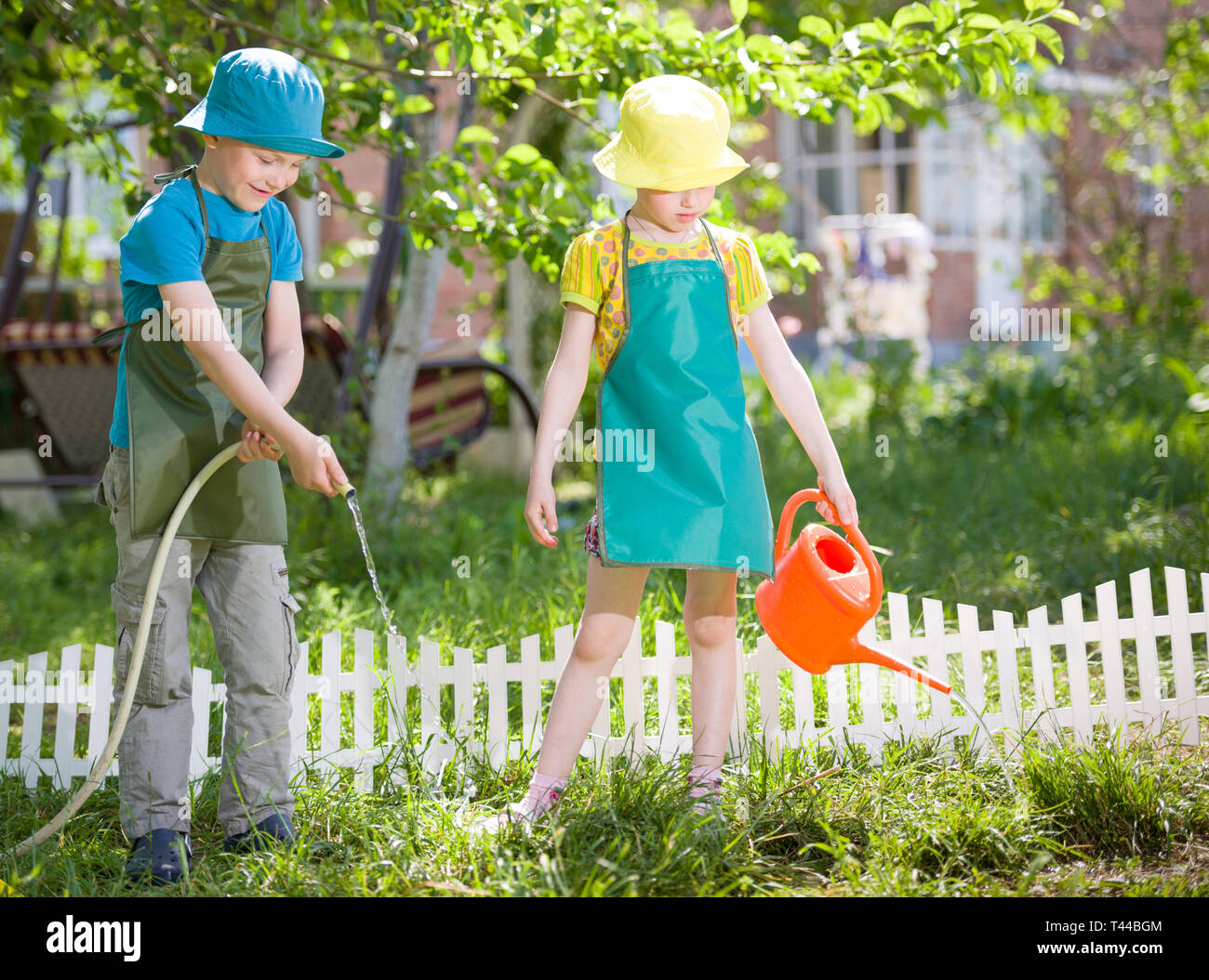 children gardening and watering Stock Photo - Alamy