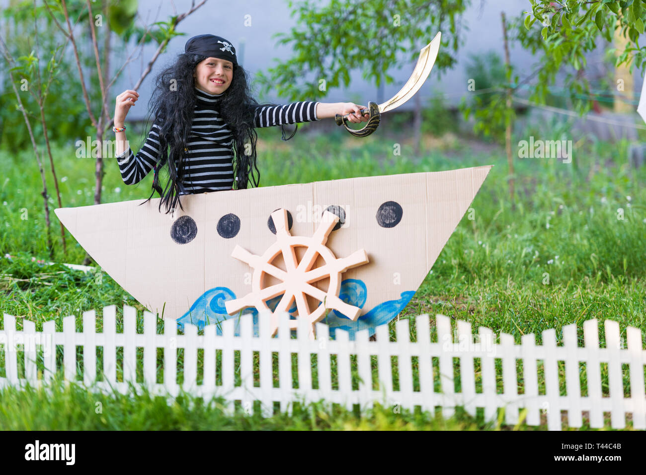 kid playing pirates at backyard Stock Photo - Alamy