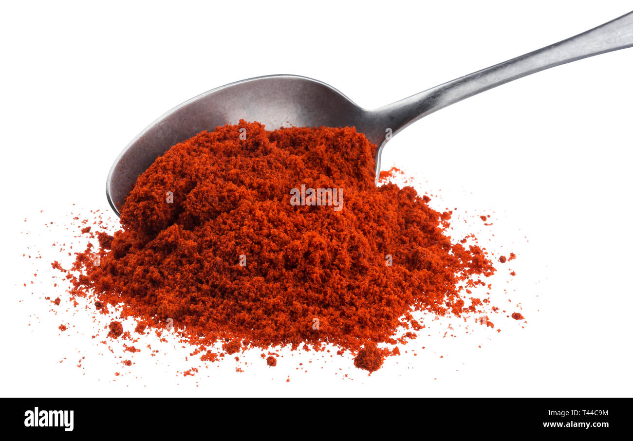 Pile of red paprika powder in spoon isolated on white background with ...