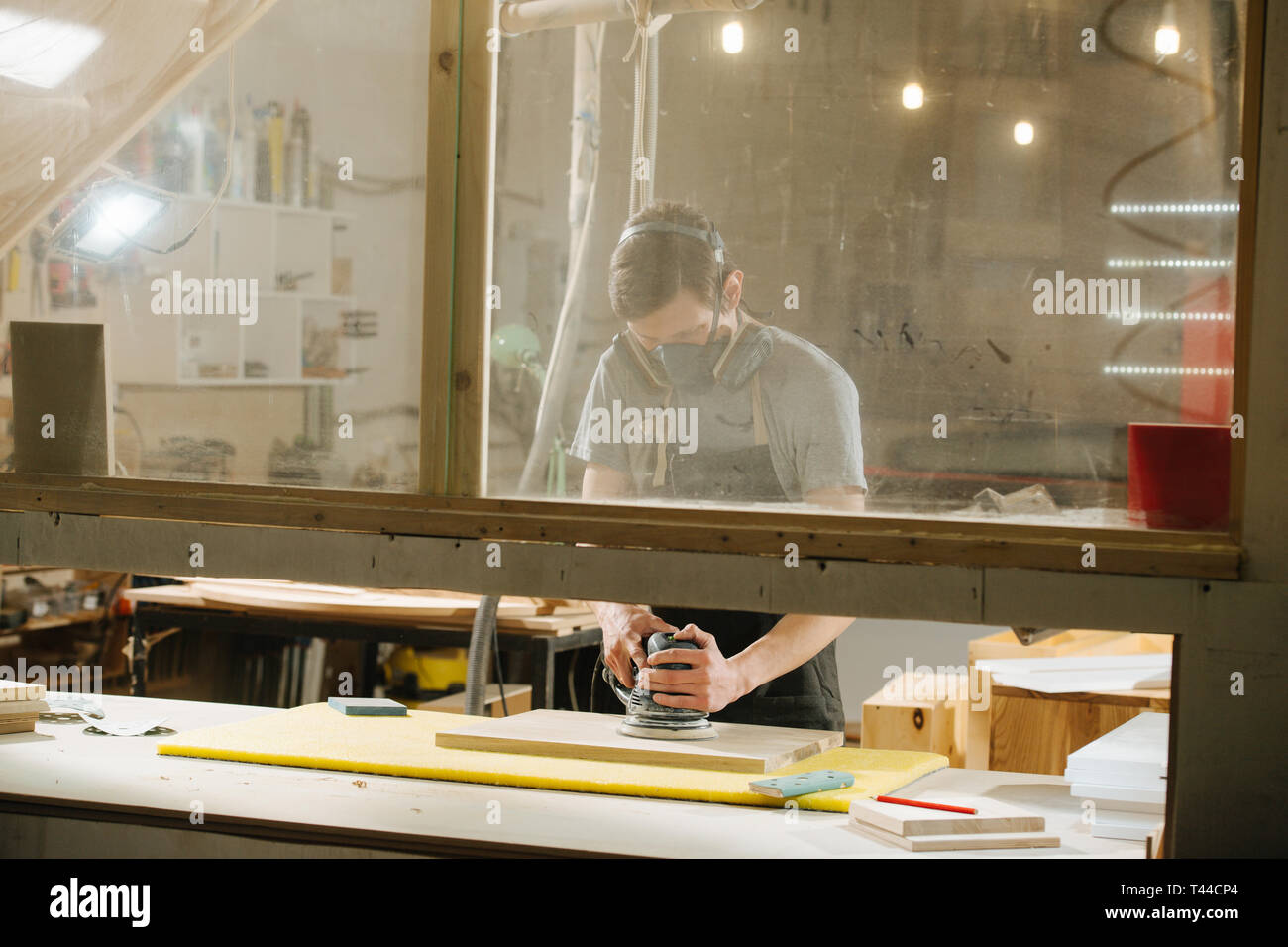 Portrait of working handsome slim middle aged brunet carpenter through ...