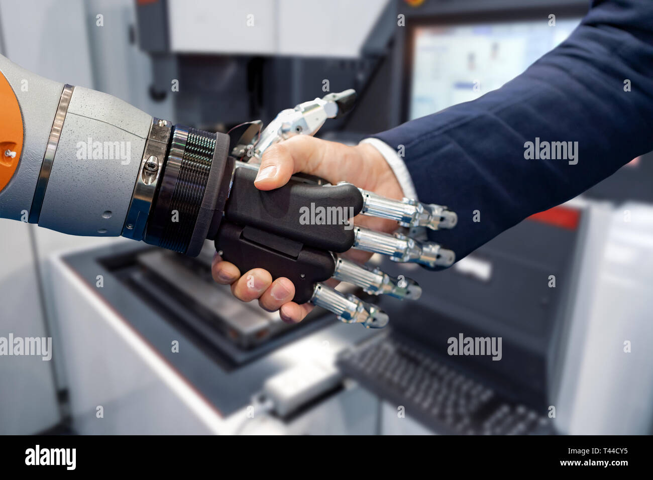 Hand of a businessman shaking hands with a Android robot. The concept ...