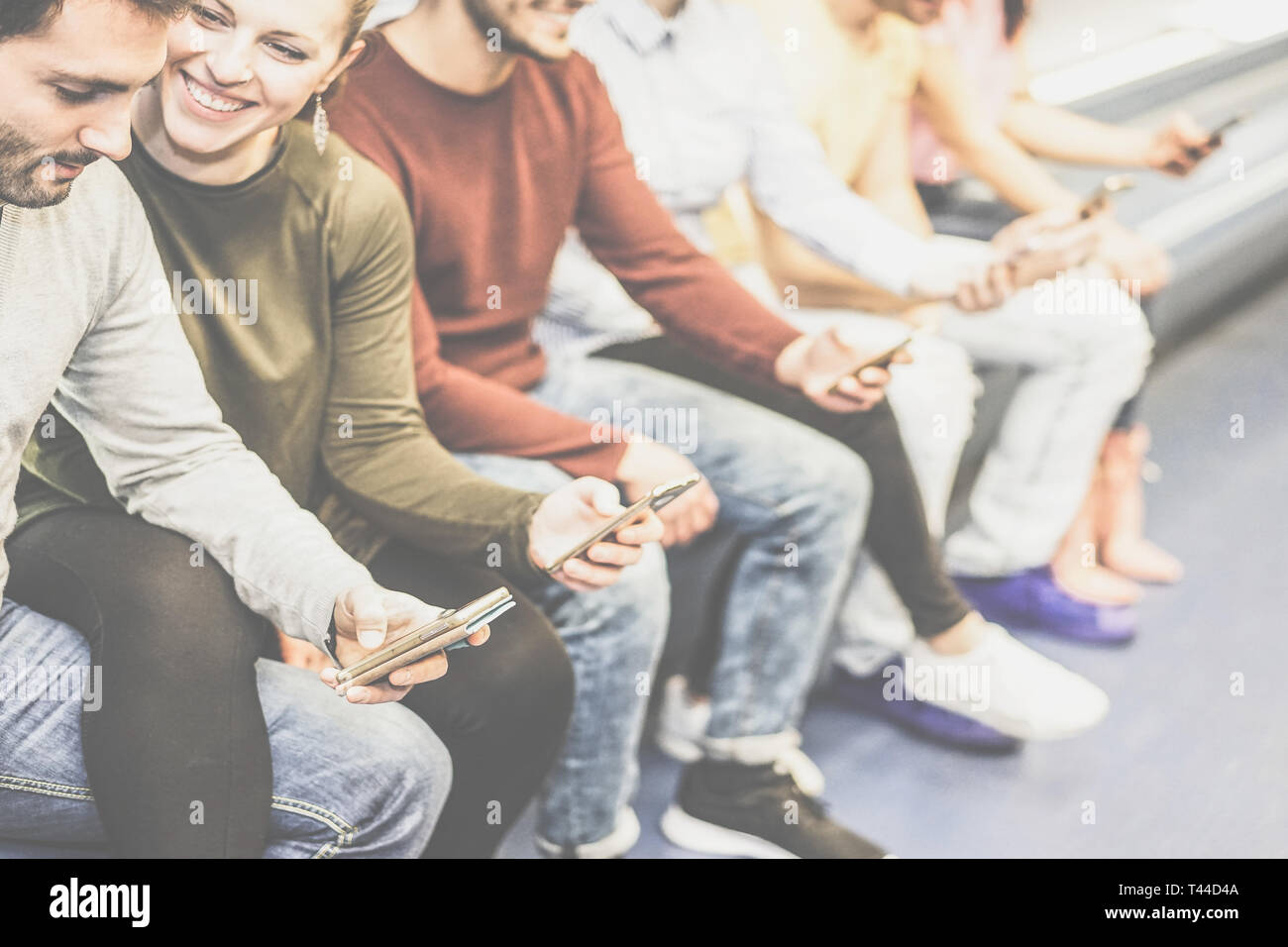 Group of friends using together their mobile smart phones while sitting ...