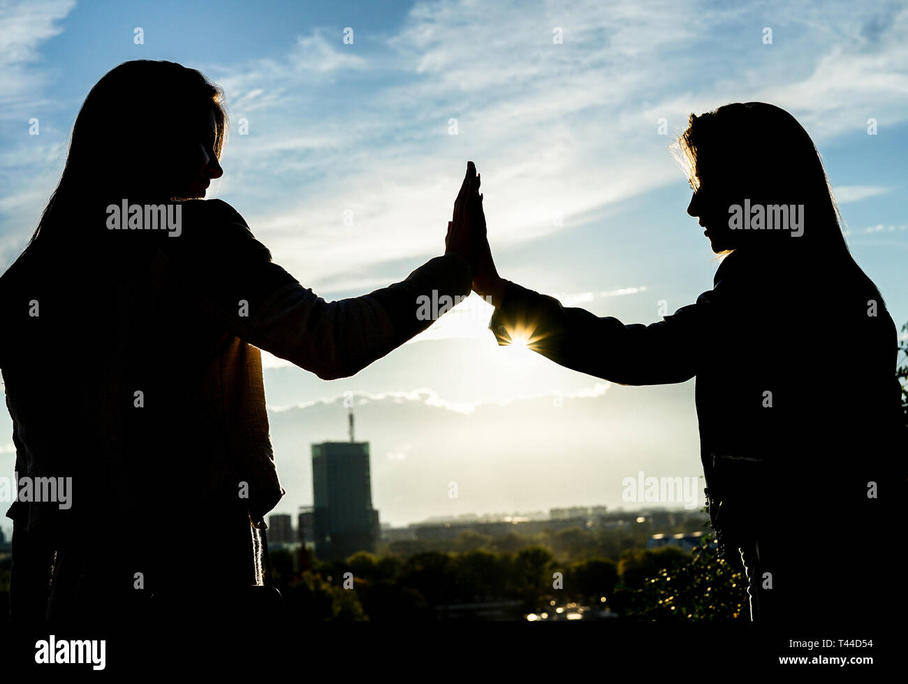 Two young women giving high five hi-res stock photography and images ...