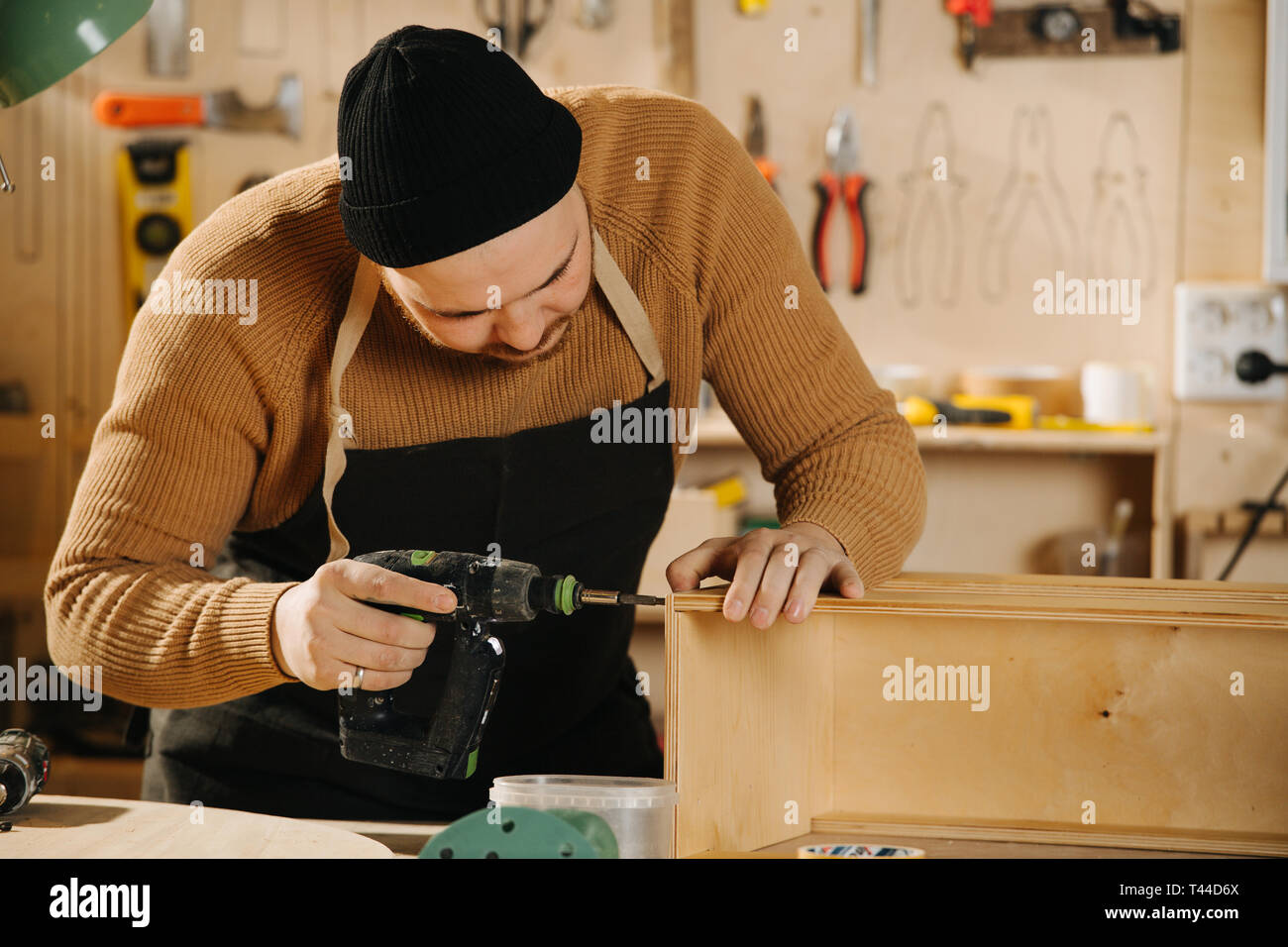 Carpenter is making furniture on order in a workshop Stock Photo - Alamy