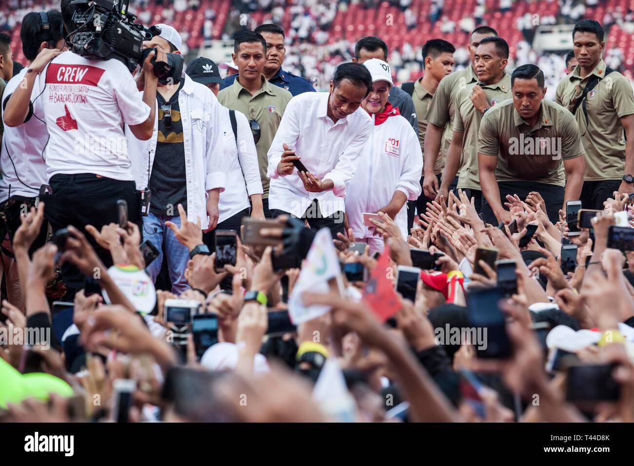 Joko Widodo seen taking selfies with his supporters during the rally ...