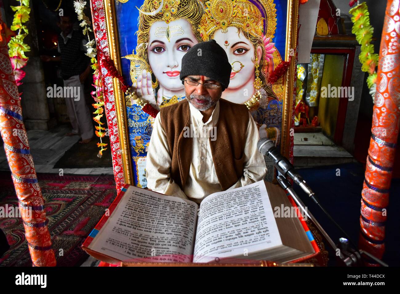 A priest seen reading the Holy Book at a temple during the occasion ...