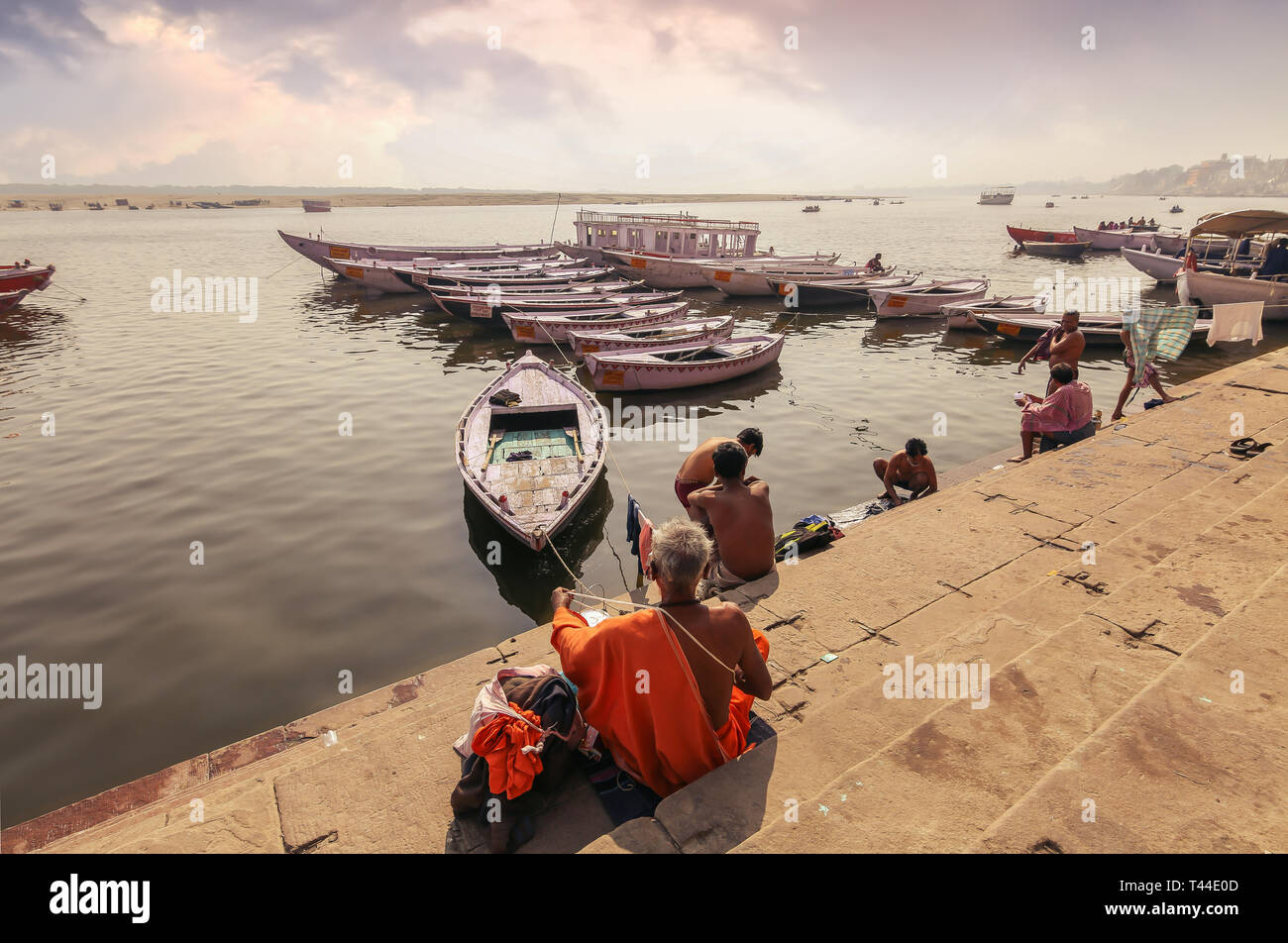 Varanasi Ganges river bank with view of wooden boats and sadhu baba ...