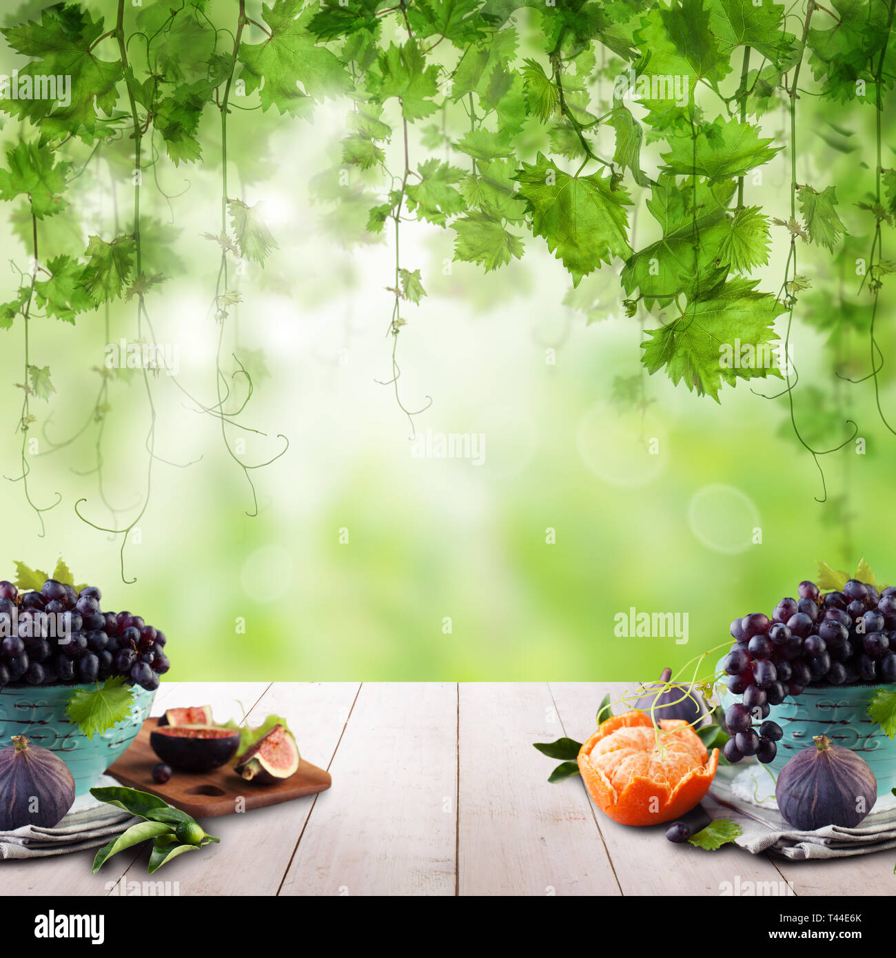 Fruit on light wooden table in sunlight garden. Natural morning ...