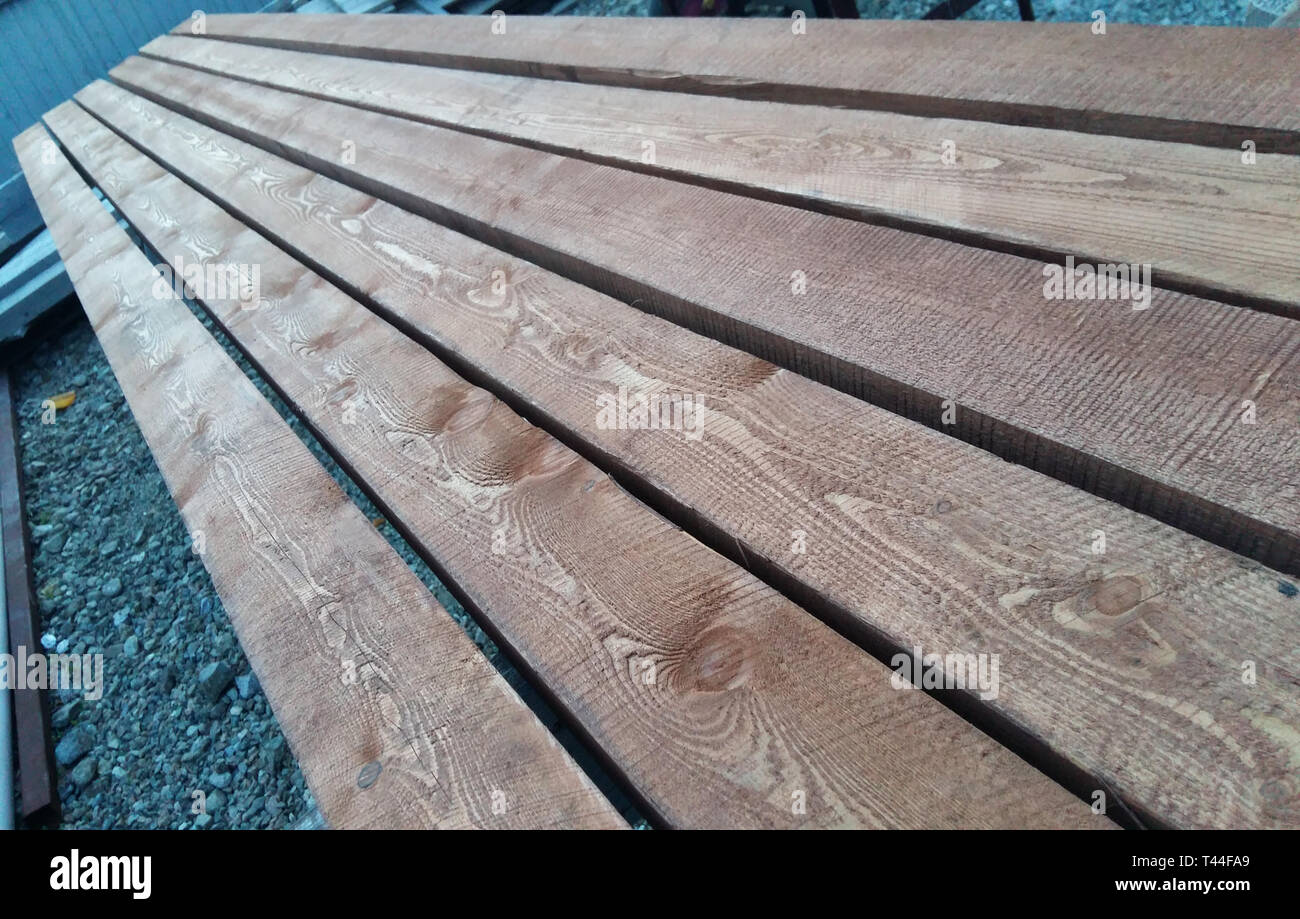 Edged boards of natural wood lie in a row unpolished with burrs Stock ...