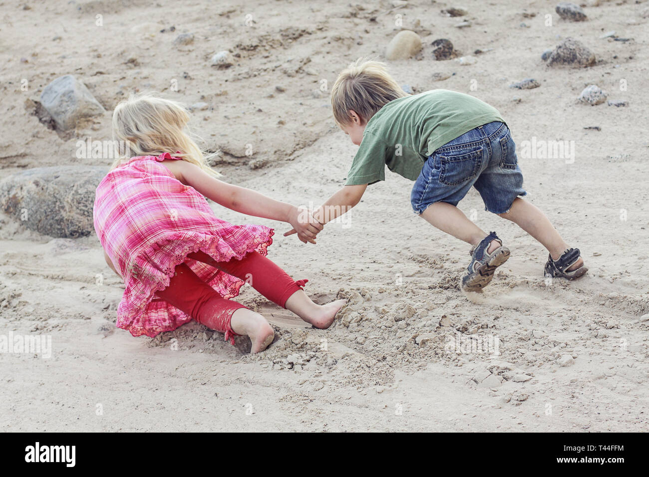 One child helping the other child. Help concept Stock Photo - Alamy