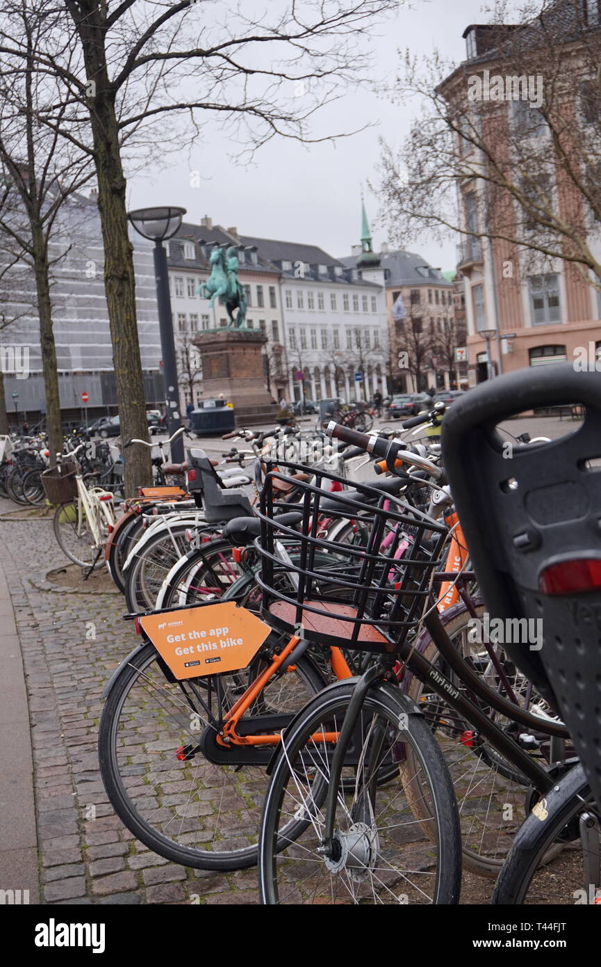 Bikes parked in the street with the statue of city founder Absalon ...