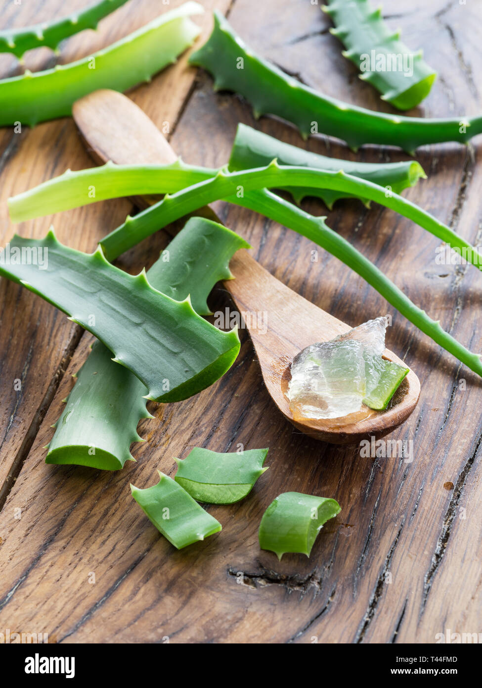 Fresh aloe leaves and aloe gel in the wooden spoon on the table Stock ...