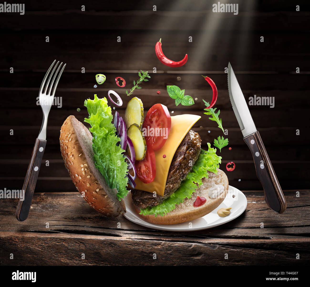 Hamburger ingredients falling down one by one to create a perfect meal ...