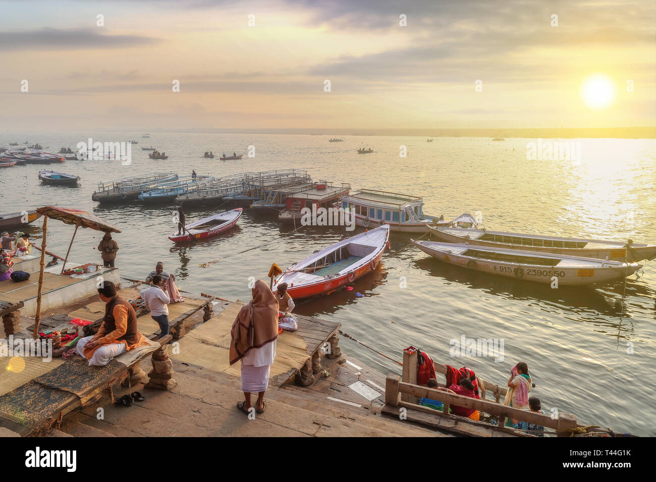 Varanasi Ganges river ghat at sunrise with tourists and pilgrims with ...