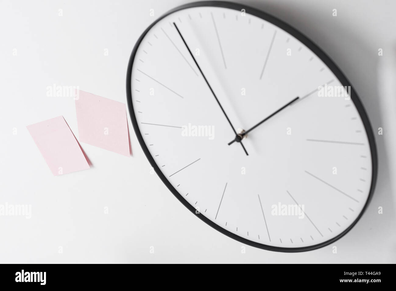 Round wall clock and two pink stickers on white background Stock Photo ...