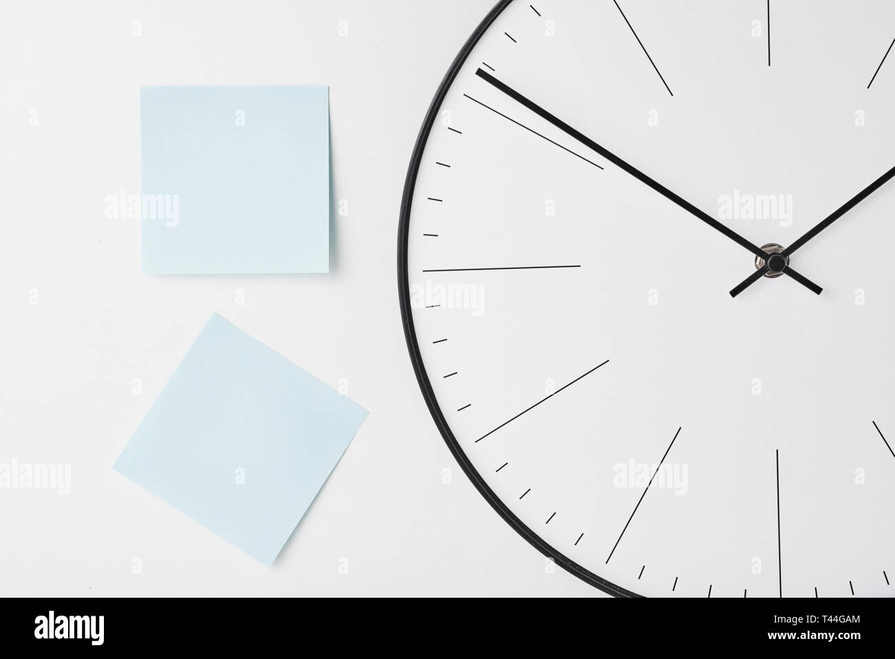 Round wall clock and two blue stickers on white background Stock Photo ...