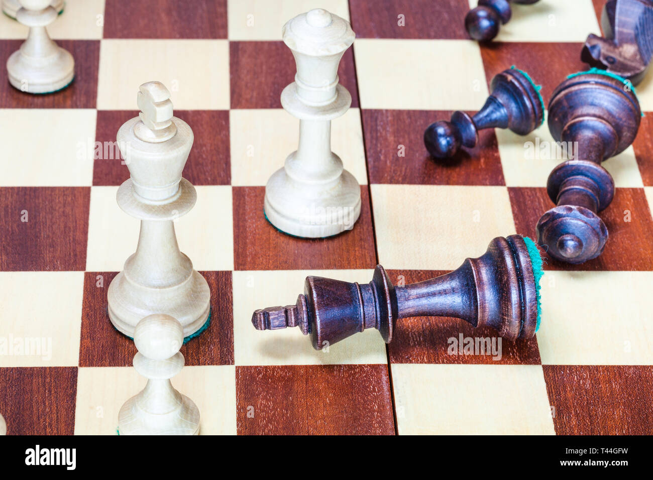 business concept - falling black chess pieces and wining white chessmen ...