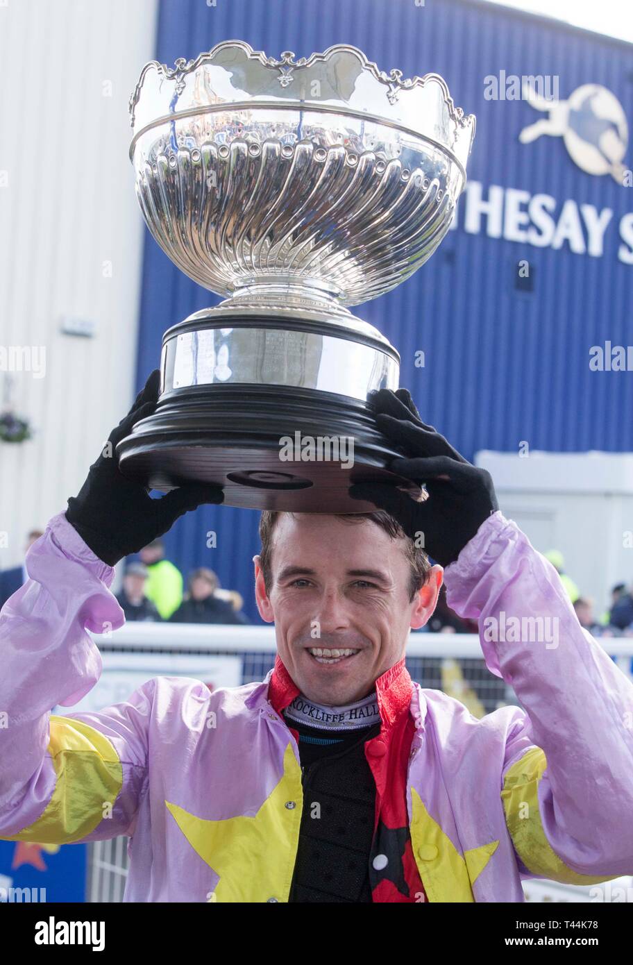 Sean Quinlan celebrates with the trophy after winning the Coral ...