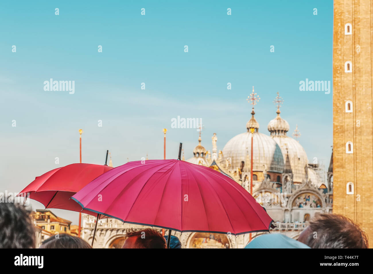 Red umbrellas of tour guides conducting tours on the background of the ...