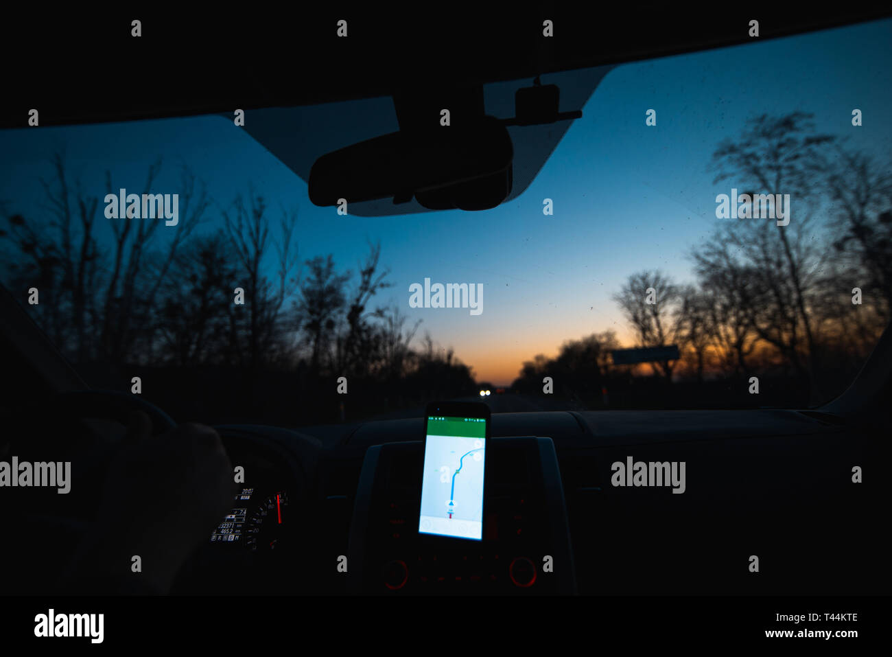 view from inside of car navigation on phone. sunrise. car travel ...